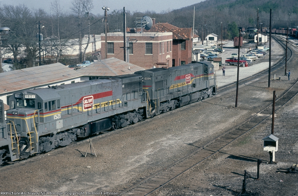SBD U30C #1482 and U25C # 1521 slowing for a crew change. A look on each side of tracks reveals ...